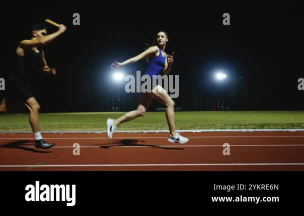 Athletes couple, male and female running a relay race and pass the ...