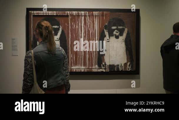 Amsterdam, Netherlands - 28 August, 2024: Close-up view of Banksy artwork featuring two monkeys ...