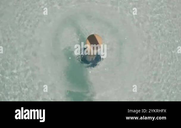 Top-down view of a circular water fountain with rippling water patterns ...