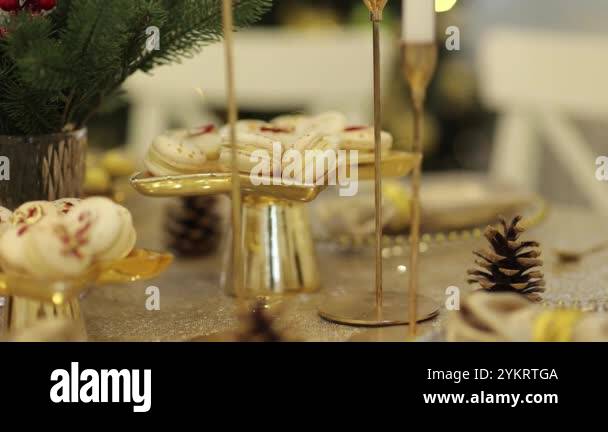 Christmas dinner table setting at home with fir branches, candles, cone ...