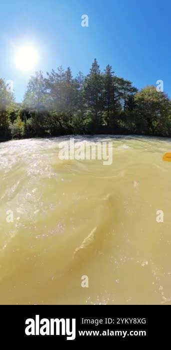 Vertical video. Close-up of a fast-moving river during a rafting ...