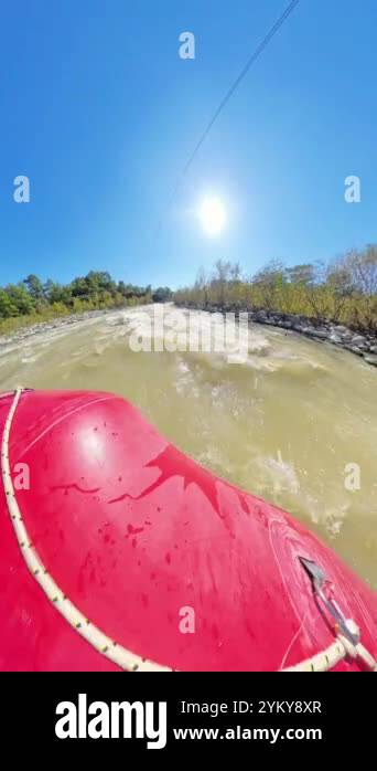 Vertical video. A 360-degree view of a rafting boat navigating down a ...