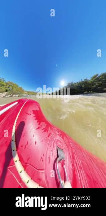 Vertical video. A head-on view of a splash hitting a rafting boat as it ...