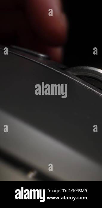 Vertical video. detailed close-up of a hand on a mouse scroll wheel ...