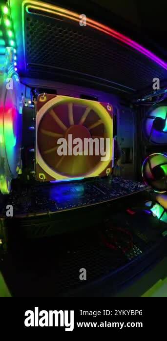 Vertical video. A zoomed-in view inside a gaming PC, featuring a hand ...