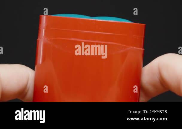 Hands demonstrating the mechanism of a retractable deodorant stick ...