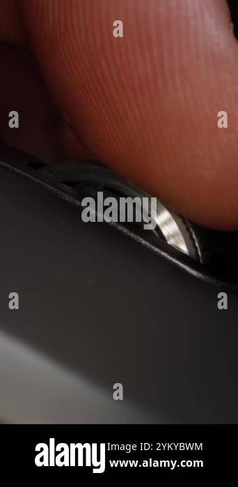 Vertical video. Slow motion, the magnetic scroll on the mouse rotates ...