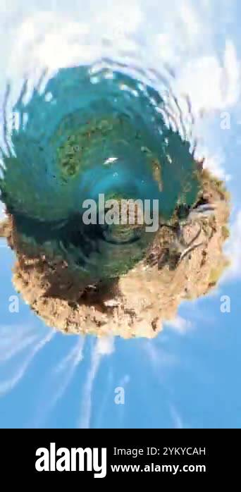Vertical video. "Tiny Planet" effect of underwater scene showing a ...
