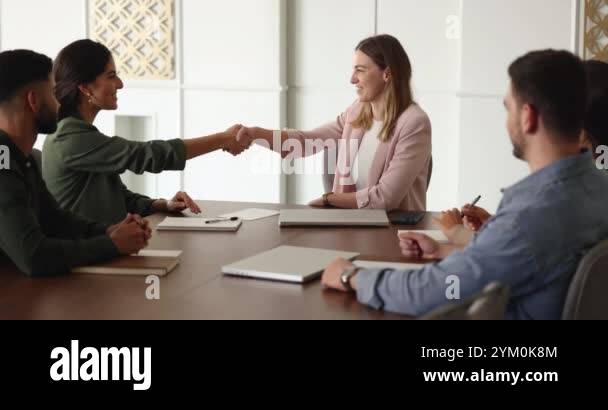 Positive successful female business leader holding meeting with team ...