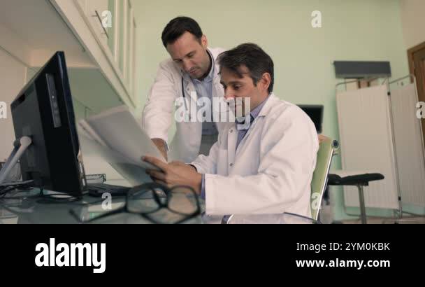 Two Latino GP, professional medical workers working together in clinic ...