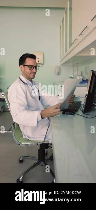 Mature professional man doctor doing paperwork checking medical ...