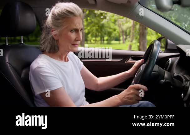 Annoyed irritated mad Caucasian mature senior elderly woman female auto ...