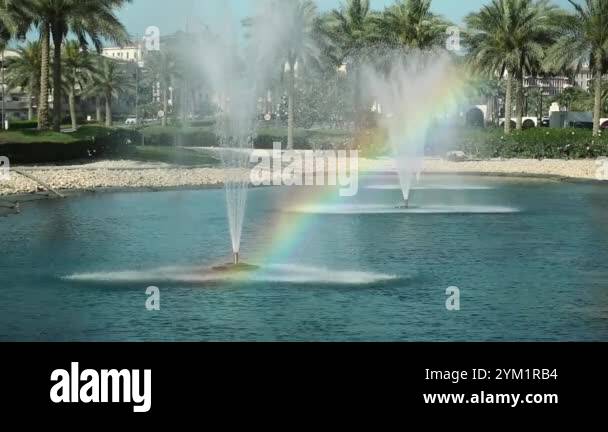 Fountains and colorful rainbow. Rainbow - meteorological phenomenon ...