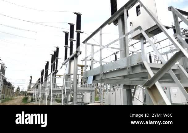 High voltage electrical substation. Power plant with high poles and voltage distribution cables ...