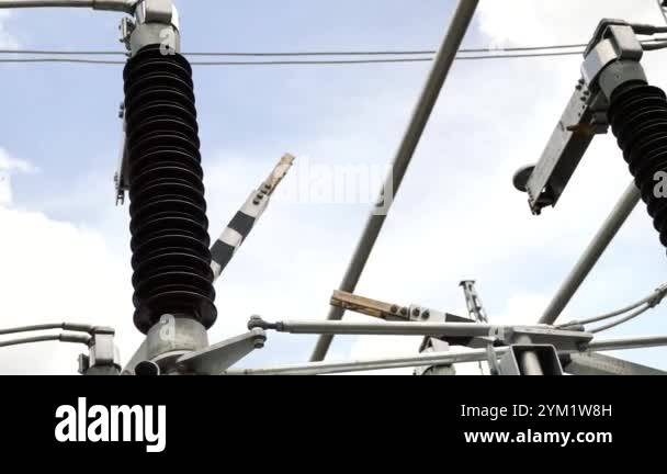 High voltage electrical substation. Power plant with high poles and voltage distribution cables ...