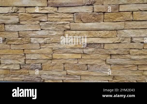 Modern gray brown, beige, metal door at the house lined with stone ...