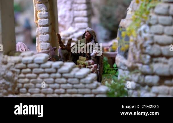 Figurine depicting a bricklayer constructing a wall, contributing to a ...