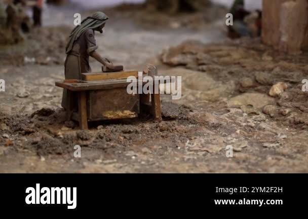 Carpenter works on a piece of wood within an animated nativity scene ...