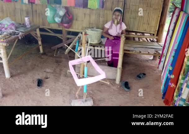 Craftswoman spinning yarn on a traditional wheel showcases the rich ...