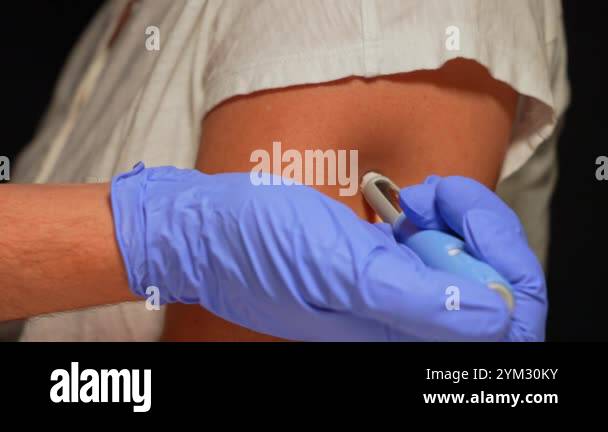 Male nurse injecting Diabetes management medication to the woman's hand ...