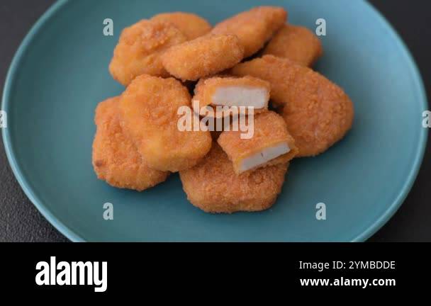 Delicious fresh crispy chicken nuggets on a dark concrete background ...