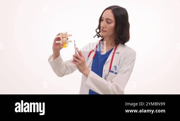 Woman doctor uses spinal cord model to describe anatomy. Female ...