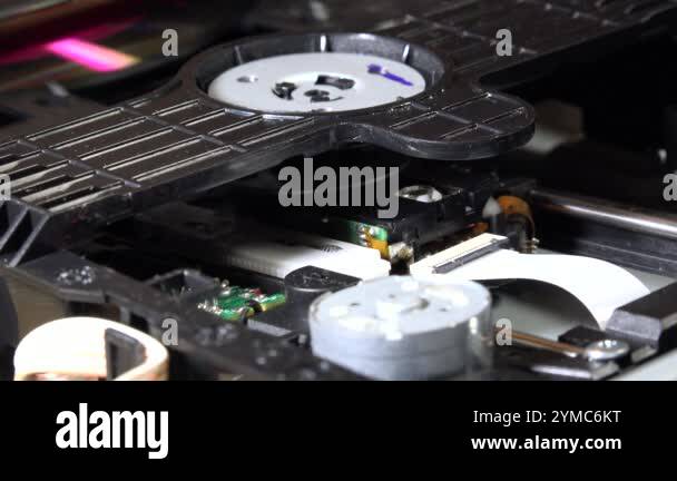 An open DVD player shows its internal components and circuitry, with ...