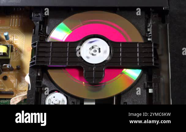 An open DVD player shows its internal components and circuitry, with ...