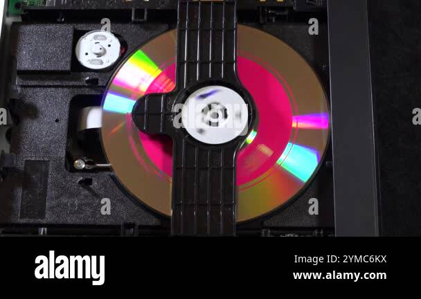 An open DVD player shows its internal components and circuitry, with ...