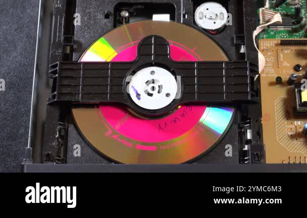 An open DVD player shows its internal components and circuitry, with ...