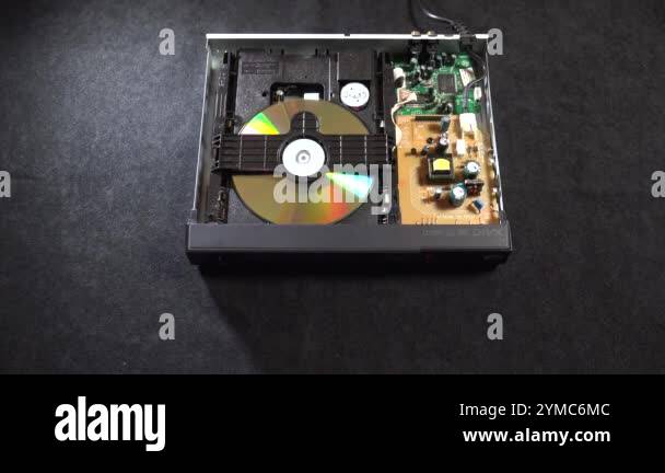 An open DVD player shows its internal components and circuitry, with ...