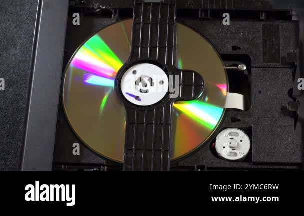 An open DVD player shows its internal components and circuitry, with ...