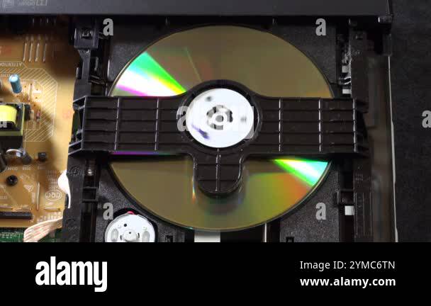 An open DVD player shows its internal components and circuitry, with ...