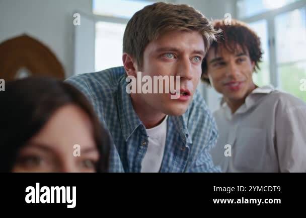 Emotional men playing playstation game feeling involved at home closeup ...