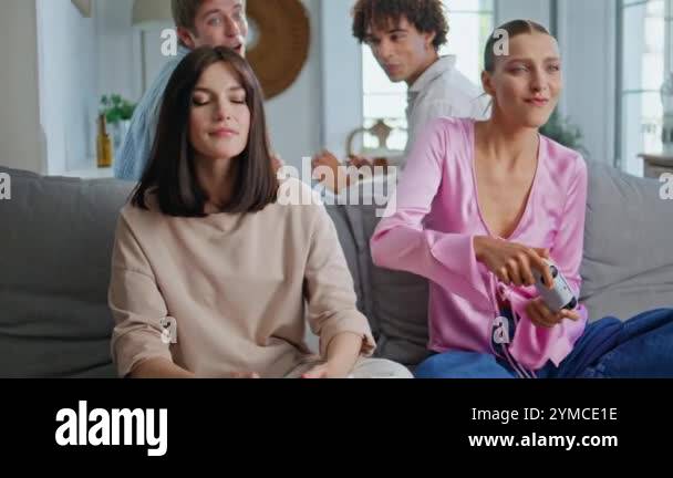 Two girls holding joysticks playing video game at home closeup. Happy ...