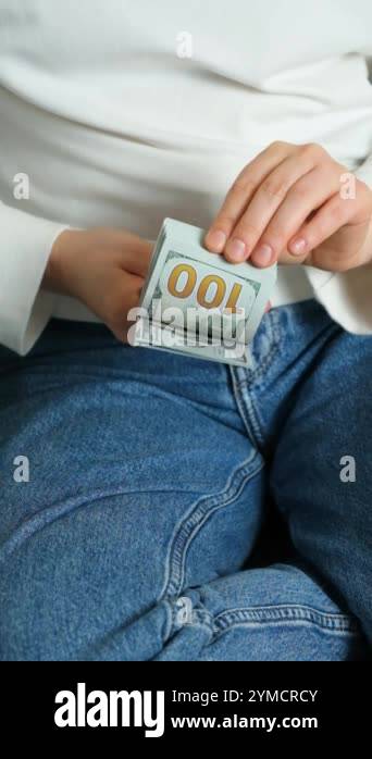 A stack of hundred-dollar bills in hands, the concept of accumulating ...