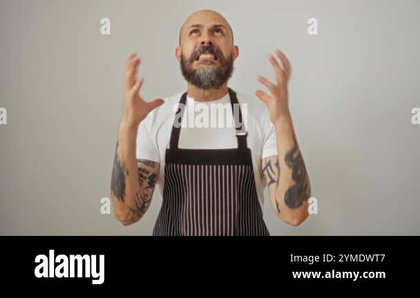 Man bald wearing apron standing with mad expression shouting and ...