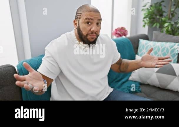 Baffled african american man, arms raised in shrug, expressing ...