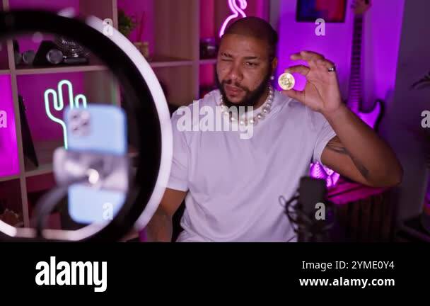 Grinning african american streamer holds bitcoin, flashes cool 'ok ...