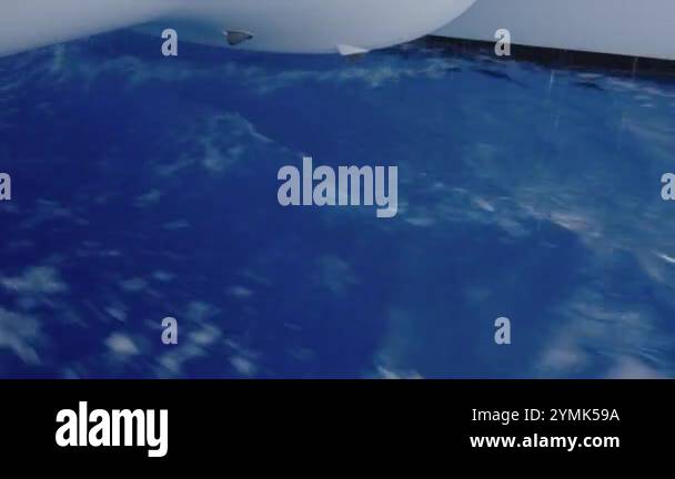 A traveling boat showcases the vibrant blue ocean below, where dynamic ...