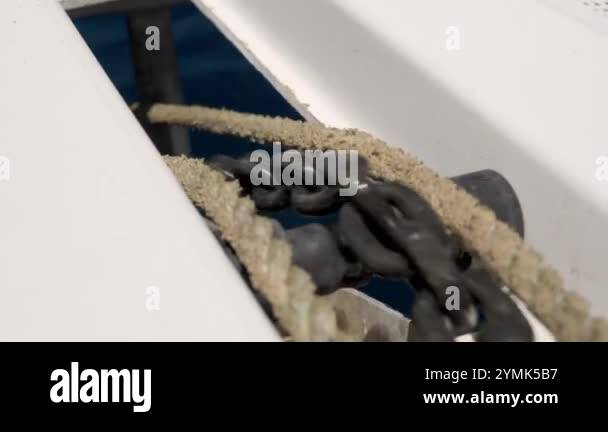 A close-up shot captures thick metal chains and ropes intertwined on a ...