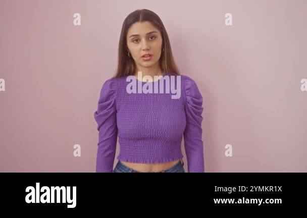 Skeptical young hispanic woman, standing thoughtfully, her face a mask ...