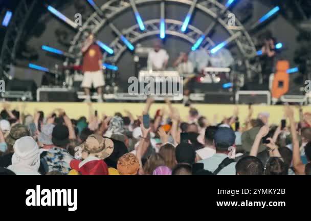 Real time back view of modern singer performing song on stage and ...