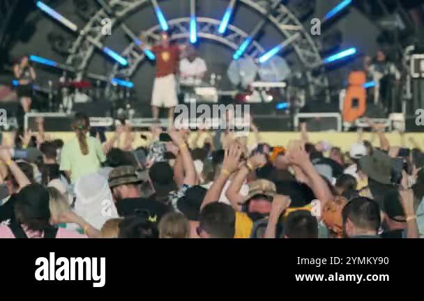 Real time back view of modern singer performing song on stage and ...