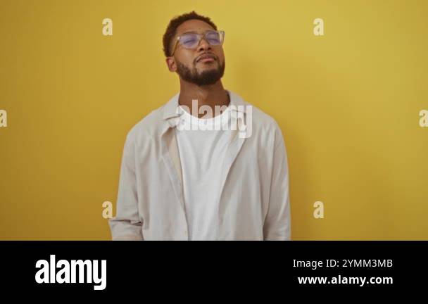Young man making a gesture of having an idea over an isolated yellow ...