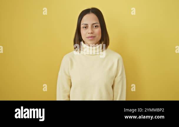 Radiant hispanic young woman standing in yellow isolated background ...