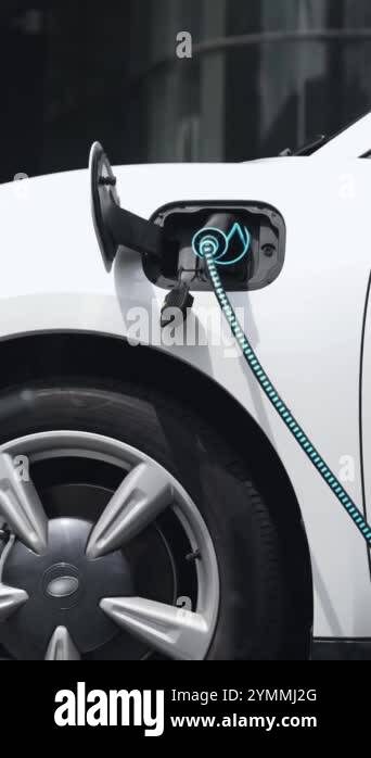 Businessman pull out EV charger from electric car from charging station ...