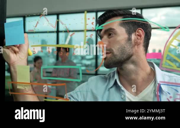 Smart project manager writing sticky notes and mind mapping at glass ...