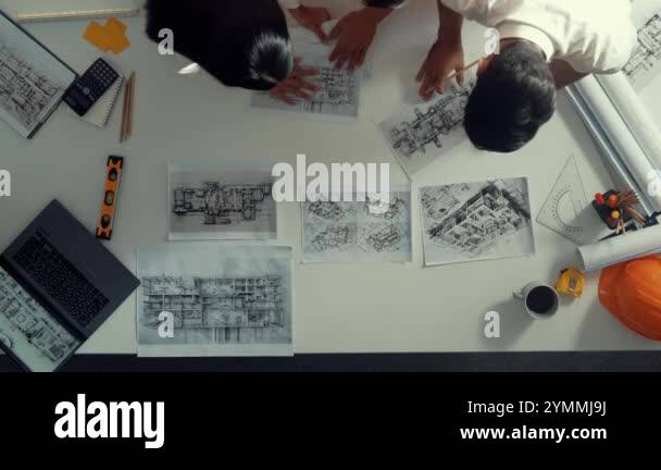 Top down view of smart architect engineer place document at meeting ...