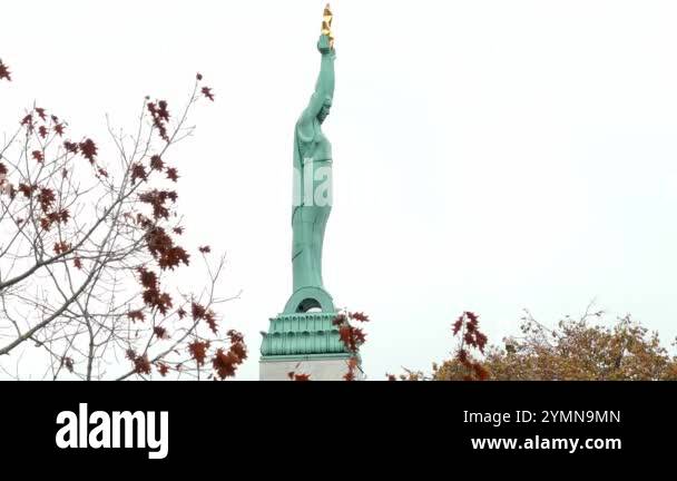 The Freedom Monument in Riga, Latvia stands tall with Liberty holding ...
